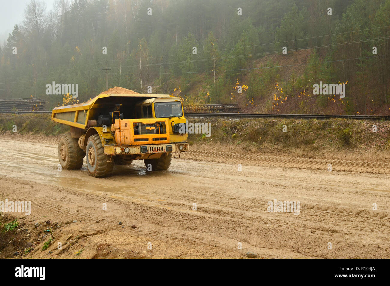 Heavy large quarry dump truck. Big wheels. The work of construction ...