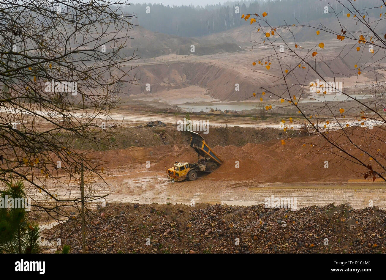 Heavy large quarry dump truck. The work of construction equipment in ...