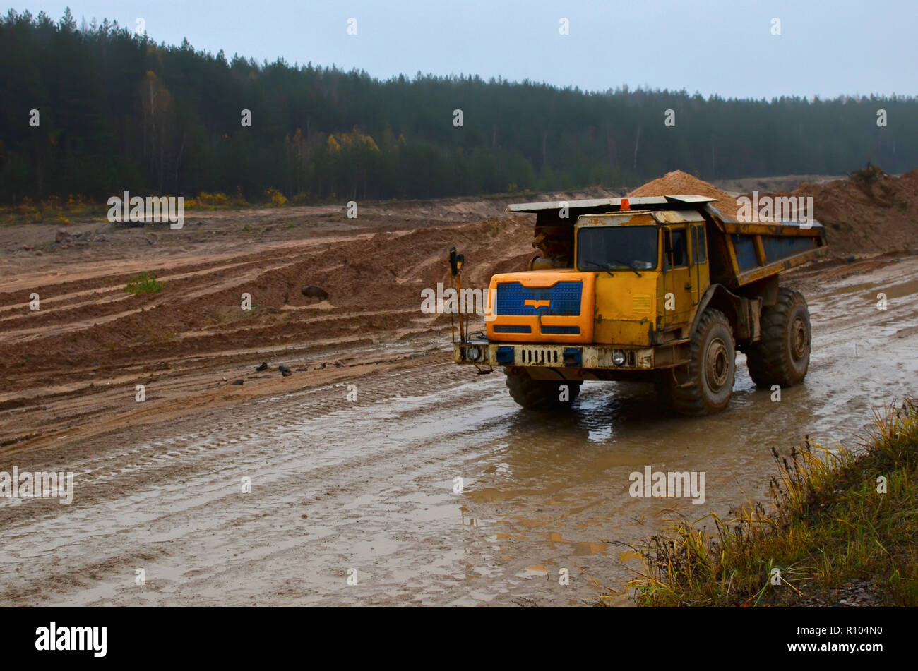 Heavy large quarry dump truck. The work of construction equipment in ...