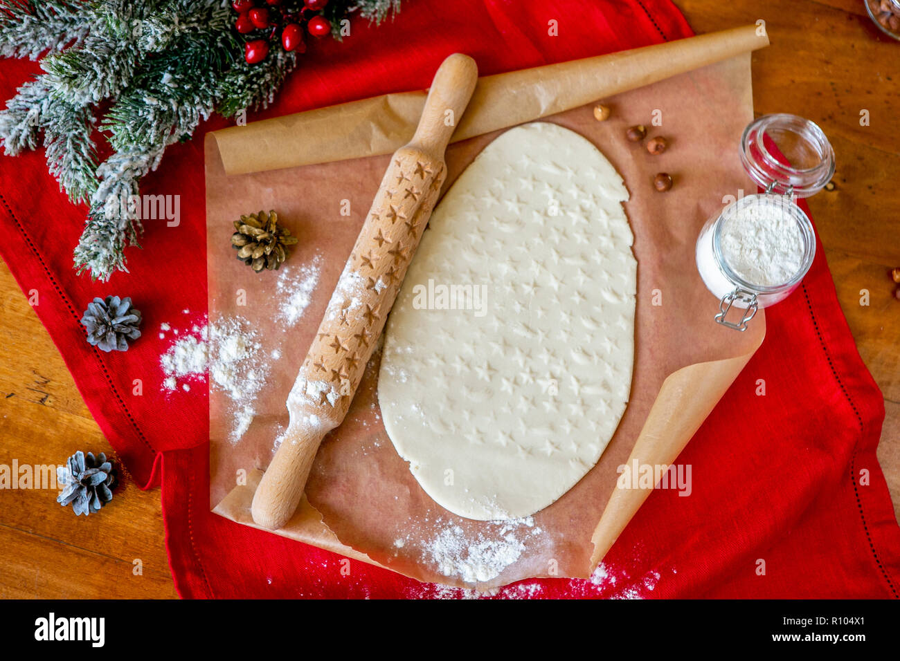 Rolling pin with a pattern on a wooden decorated table covered with ...