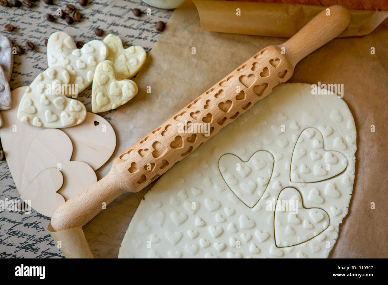 Rolling pin with a pattern on a wooden decorated table covered with ...