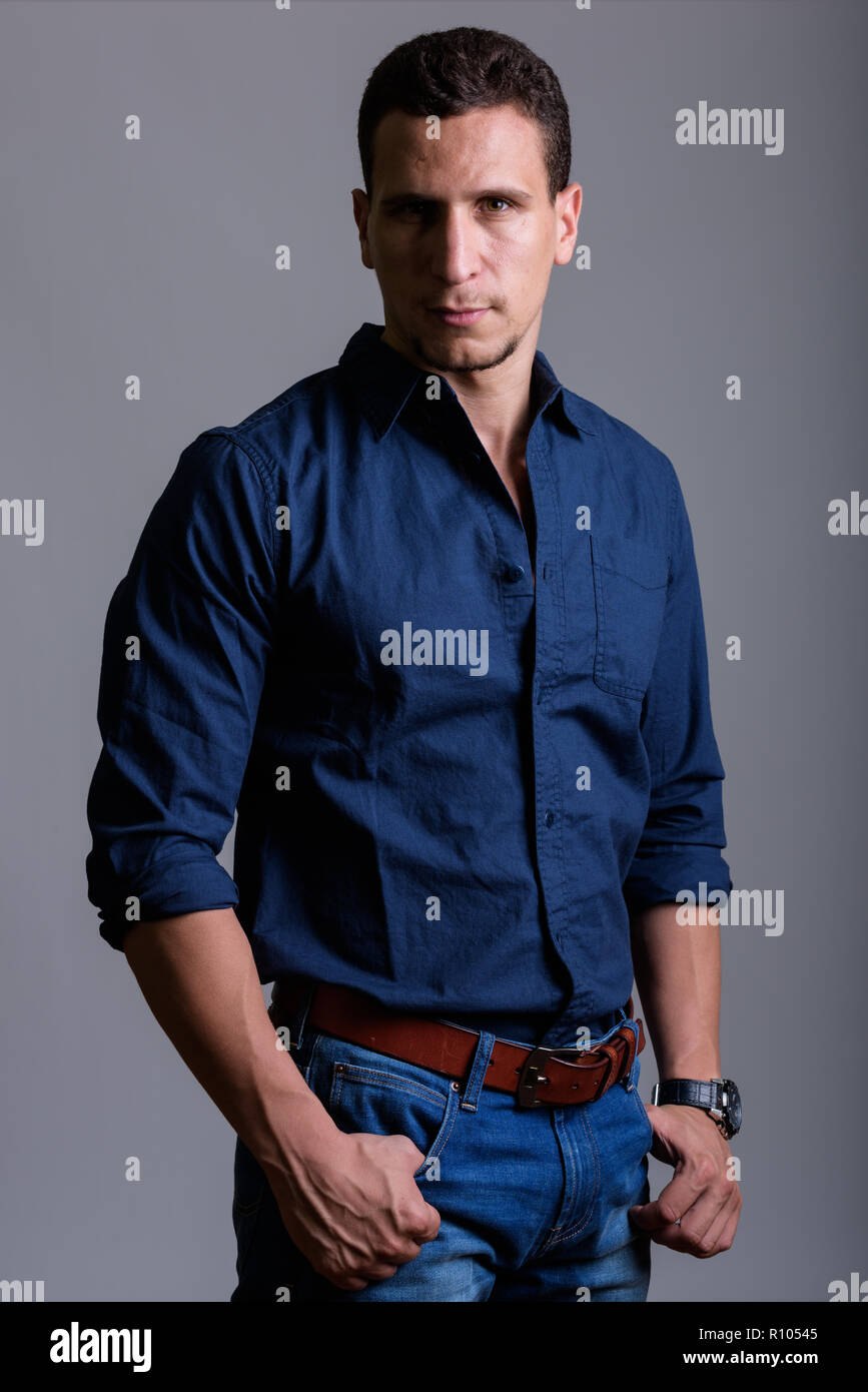 Studio shot of young muscular Persian man standing with hands on Stock ...