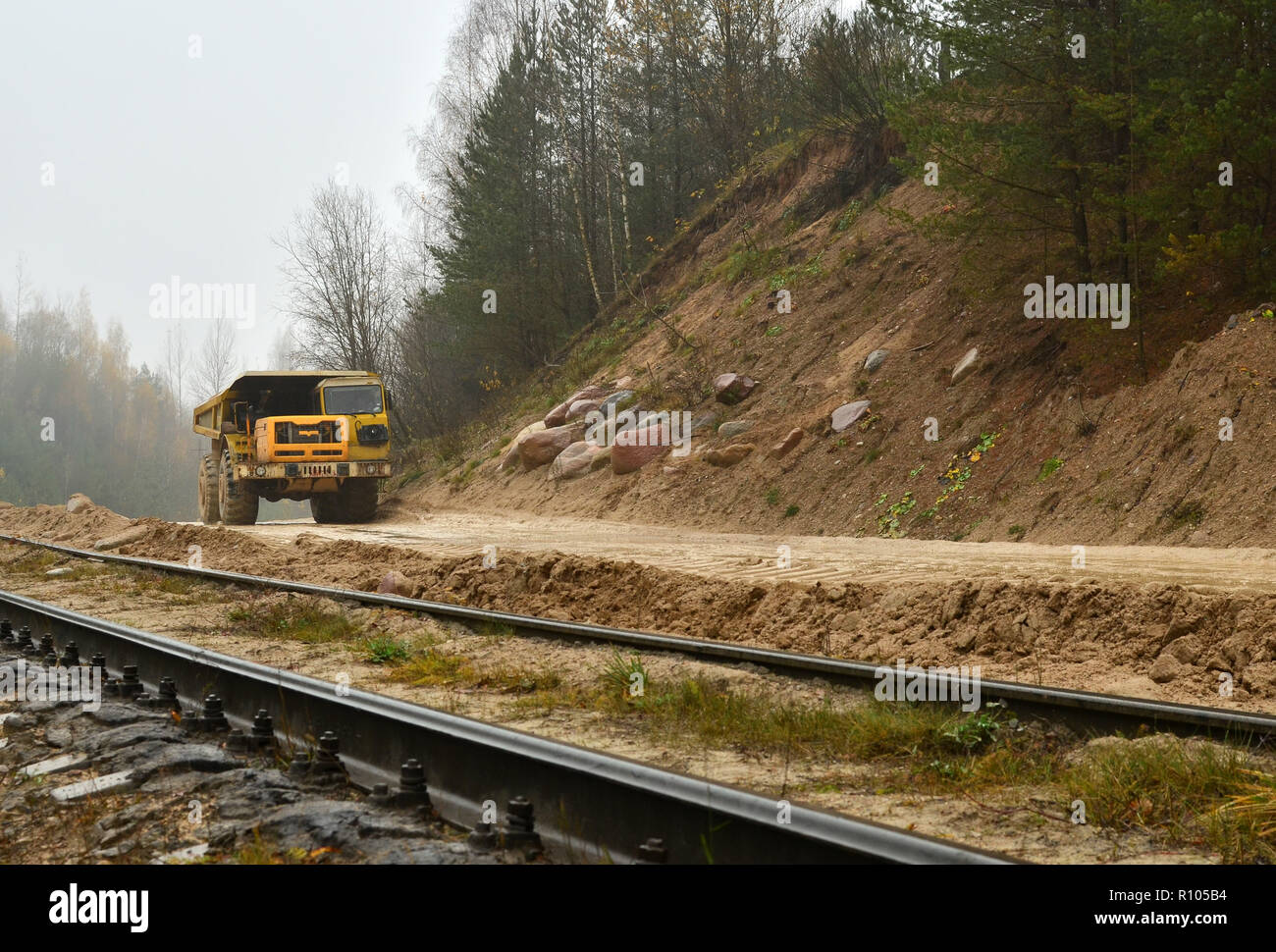 Earth mover loading dumper truck with sand in quarry. Excavator loading ...