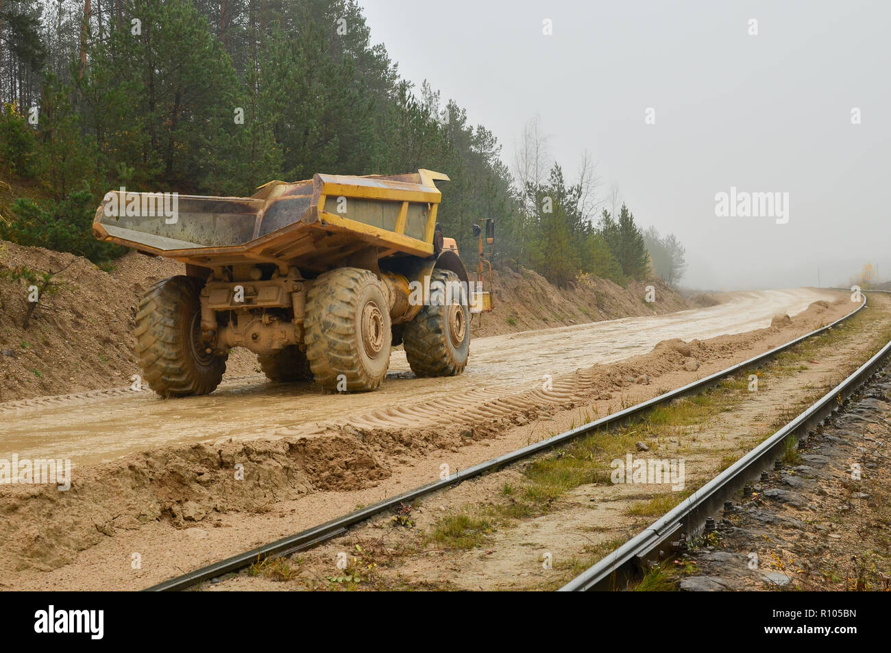 Earth mover loading dumper truck with sand in quarry. Excavator loading ...