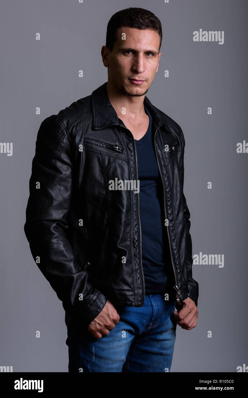 Studio shot of young muscular Persian man standing while wearing Stock ...