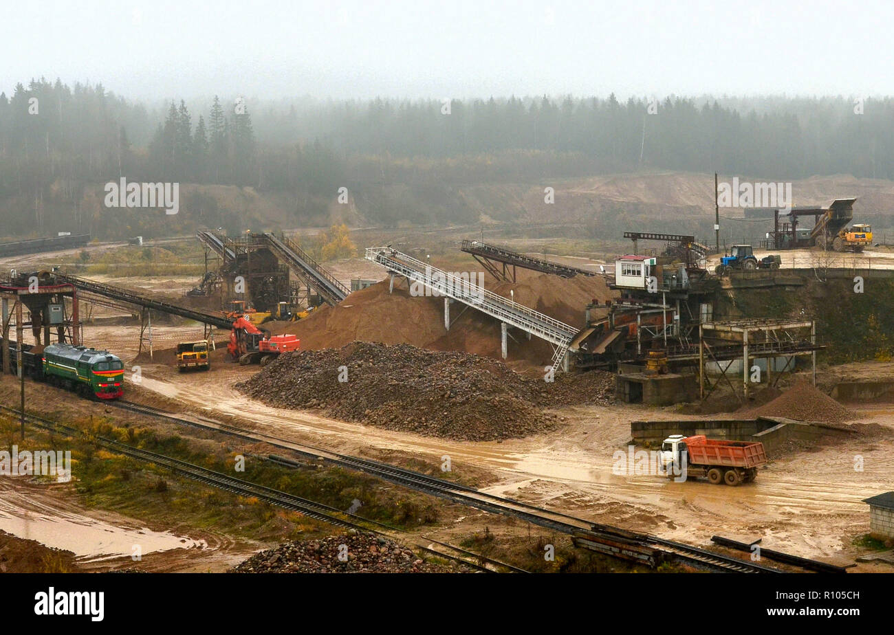 Earth mover loading dumper truck with sand in quarry. Excavator loading ...