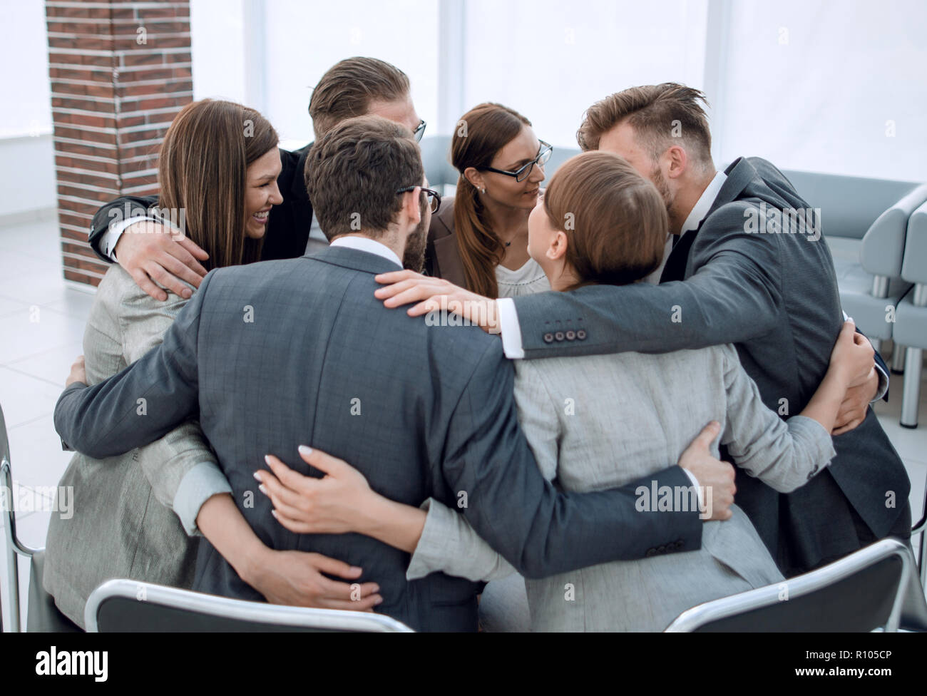 Office staff group hug hi-res stock photography and images - Alamy