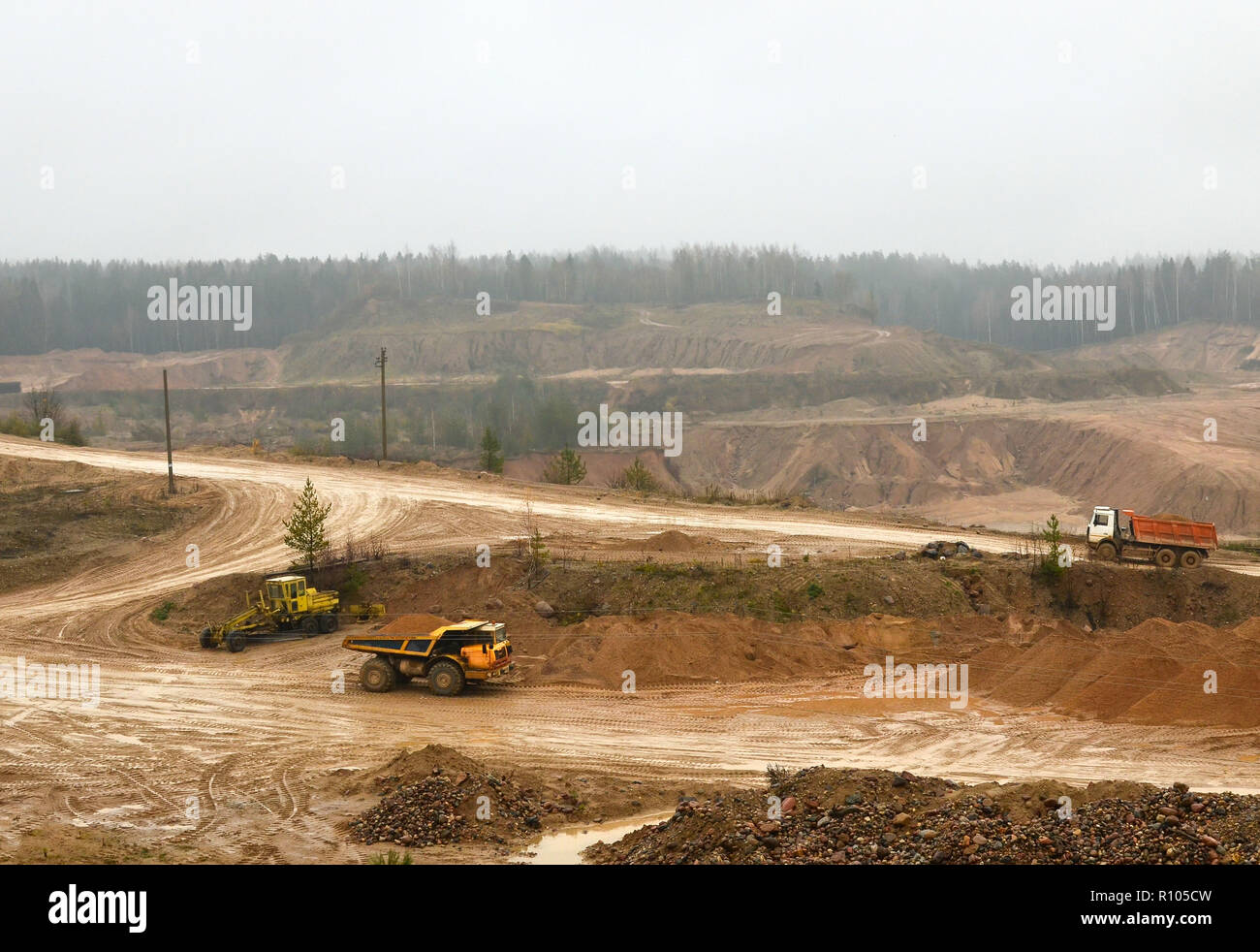 Earth mover loading dumper truck with sand in quarry. Excavator loading ...