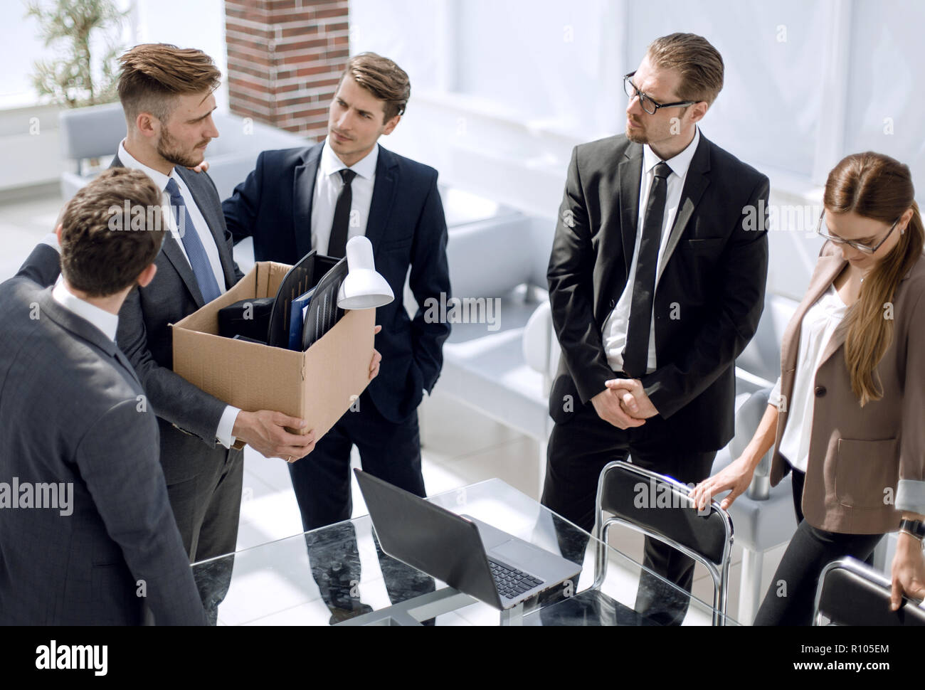sad employee with personal belongings standing in the office Stock ...