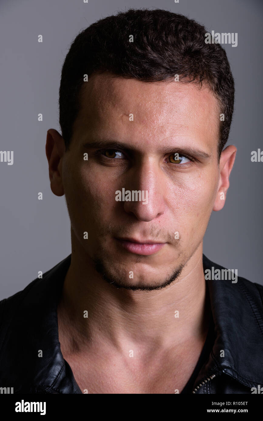 Face of young muscular Persian man thinking while looking at dis Stock ...