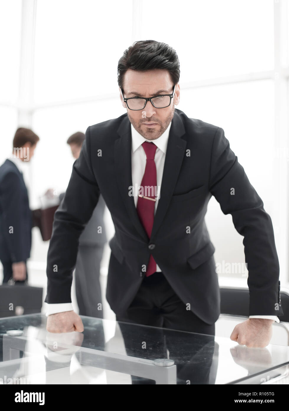 Portrait of angry concentrated director standing near desk Stock Photo ...
