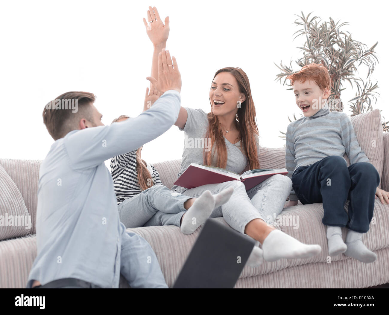 happy parents giving each other a high five Stock Photo - Alamy
