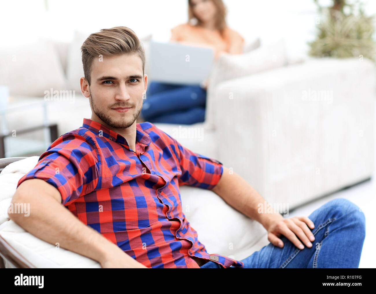 young man sitting in the big chair Stock Photo - Alamy