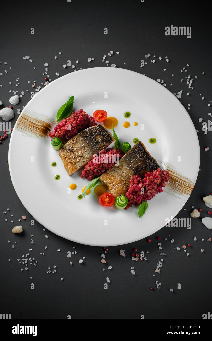 Two pieces of fried fish on white plate Stock Photo - Alamy