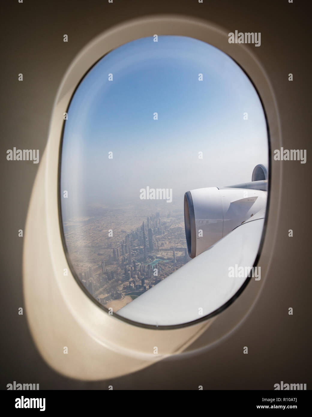 view out of a plane window mid flight looking over dubai Stock Photo ...