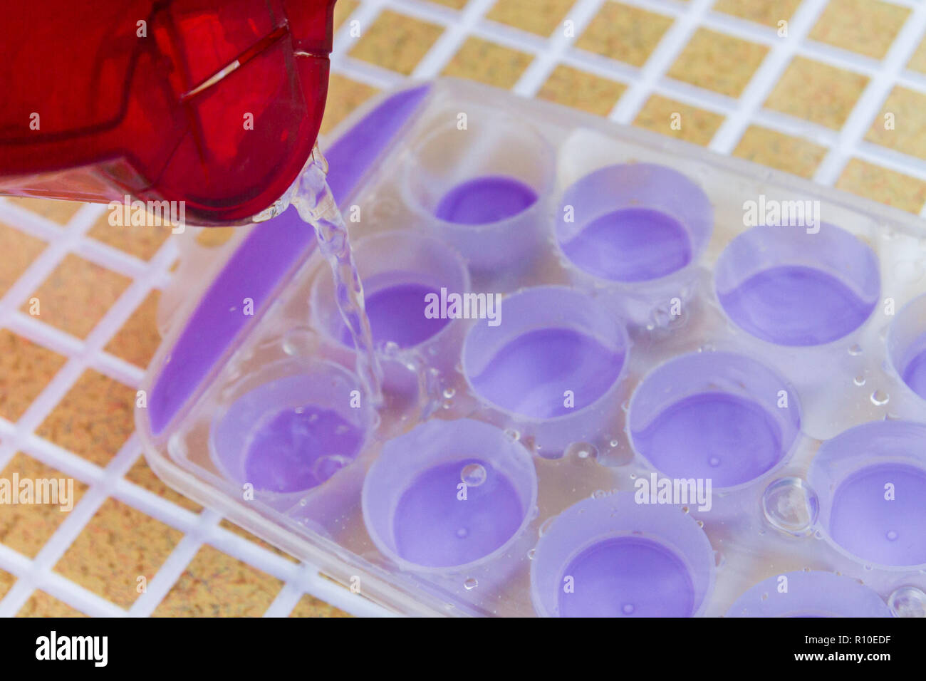 Water is poured from the filter into an ice mold Stock Photo - Alamy