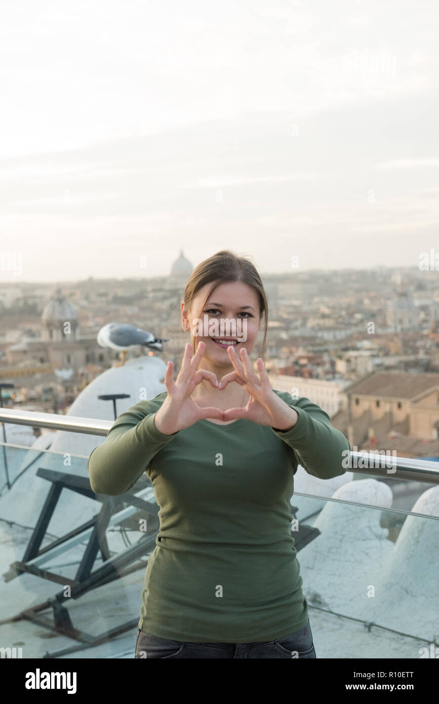 young woman wearing green pullover on the roof in front of Vatican ...