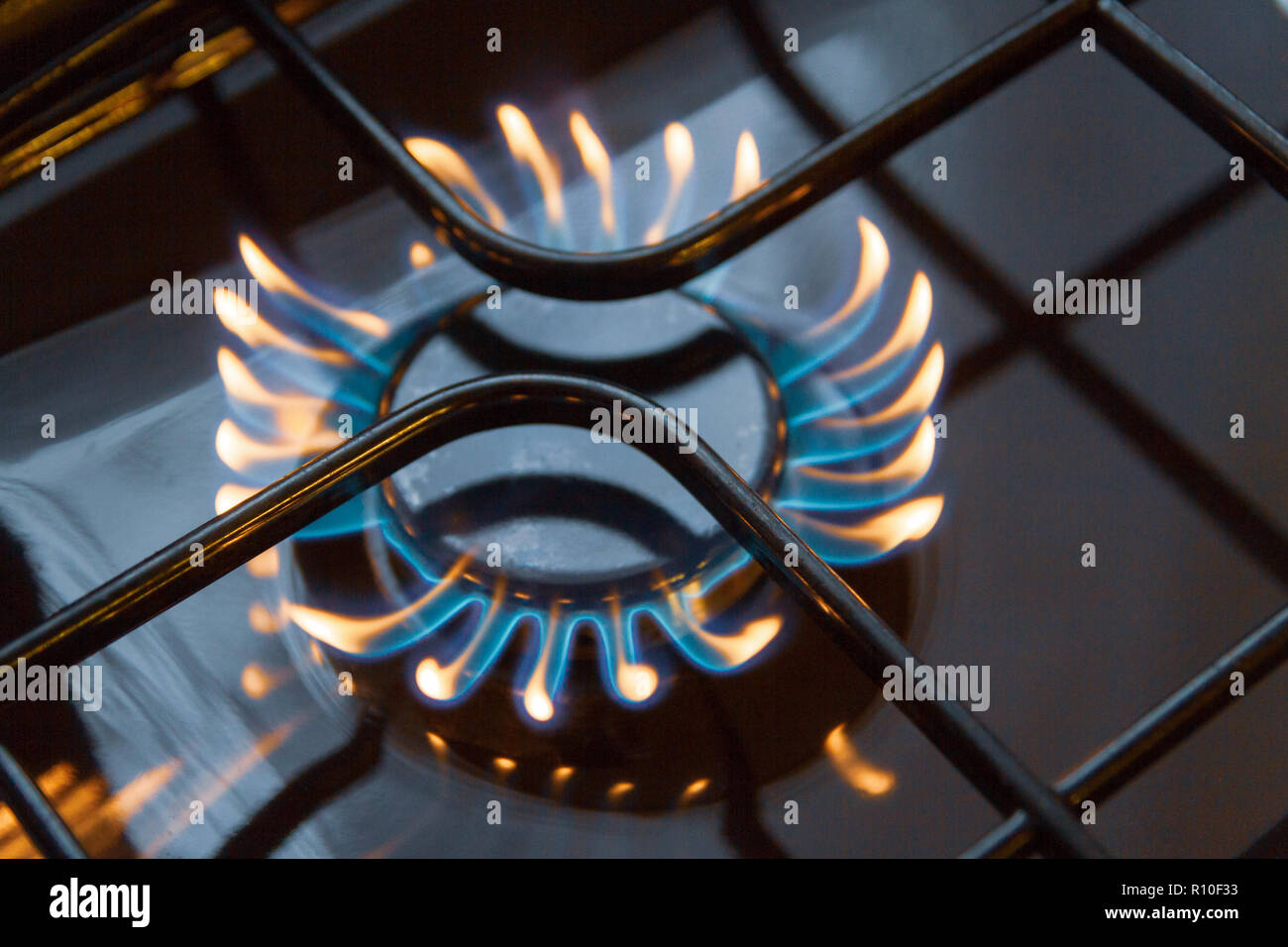 Gas stove with burning orange and blue fire on it Stock Photo - Alamy