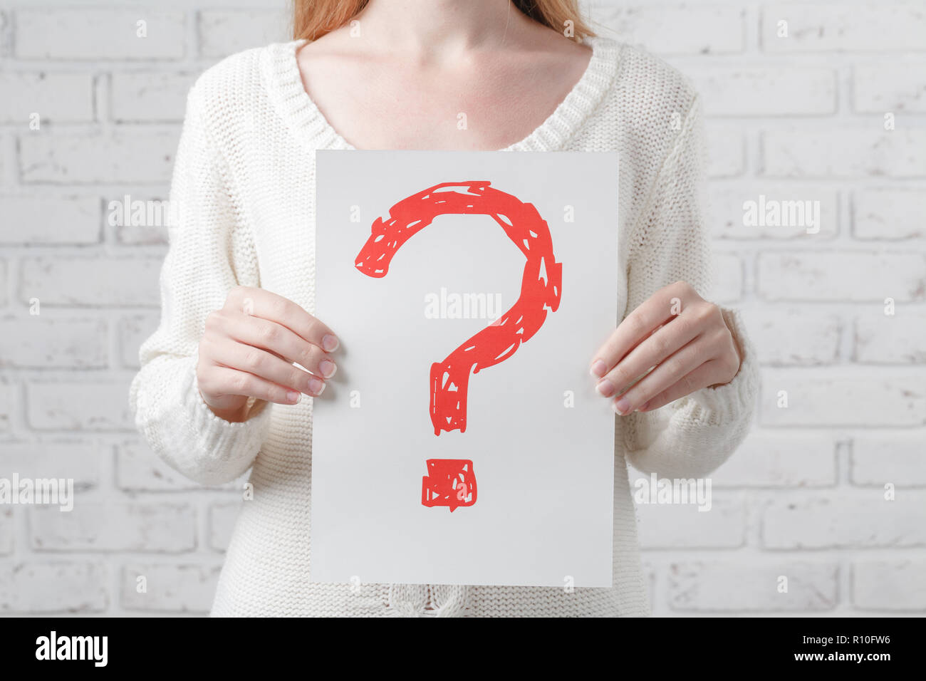 Girl holding a signboard with a question mark Stock Photo - Alamy