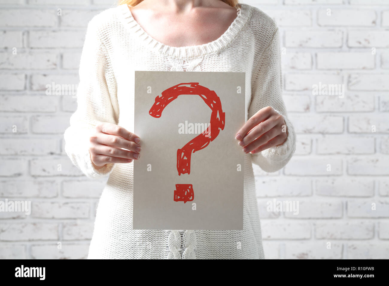 Young beautiful woman holding question on white background Stock Photo ...