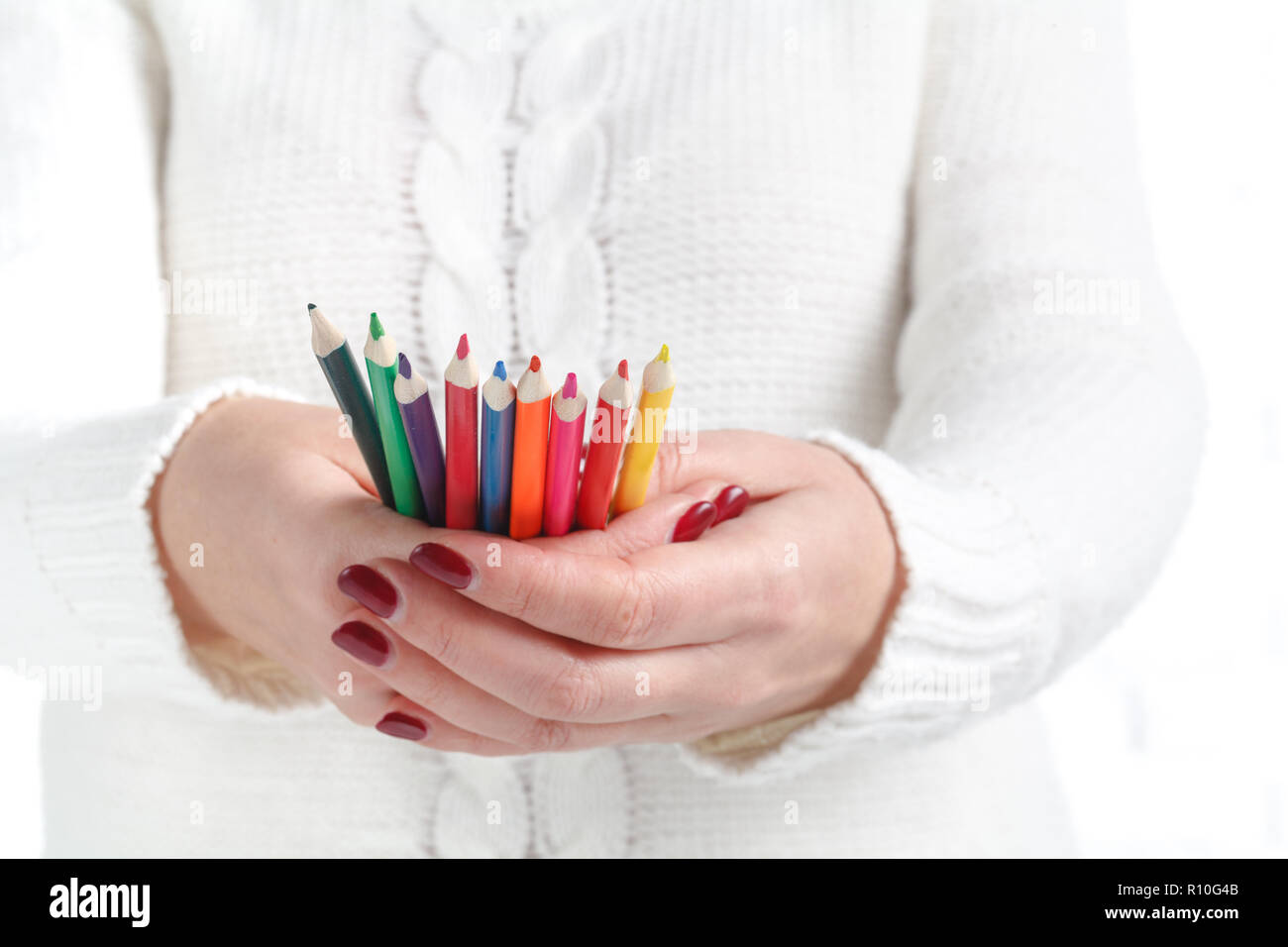 Colored pencils in hand woman Stock Photo - Alamy