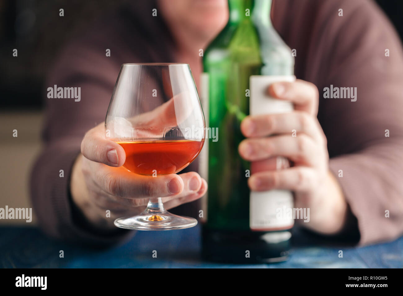 Man alone relax with alcohol after hard work Stock Photo - Alamy