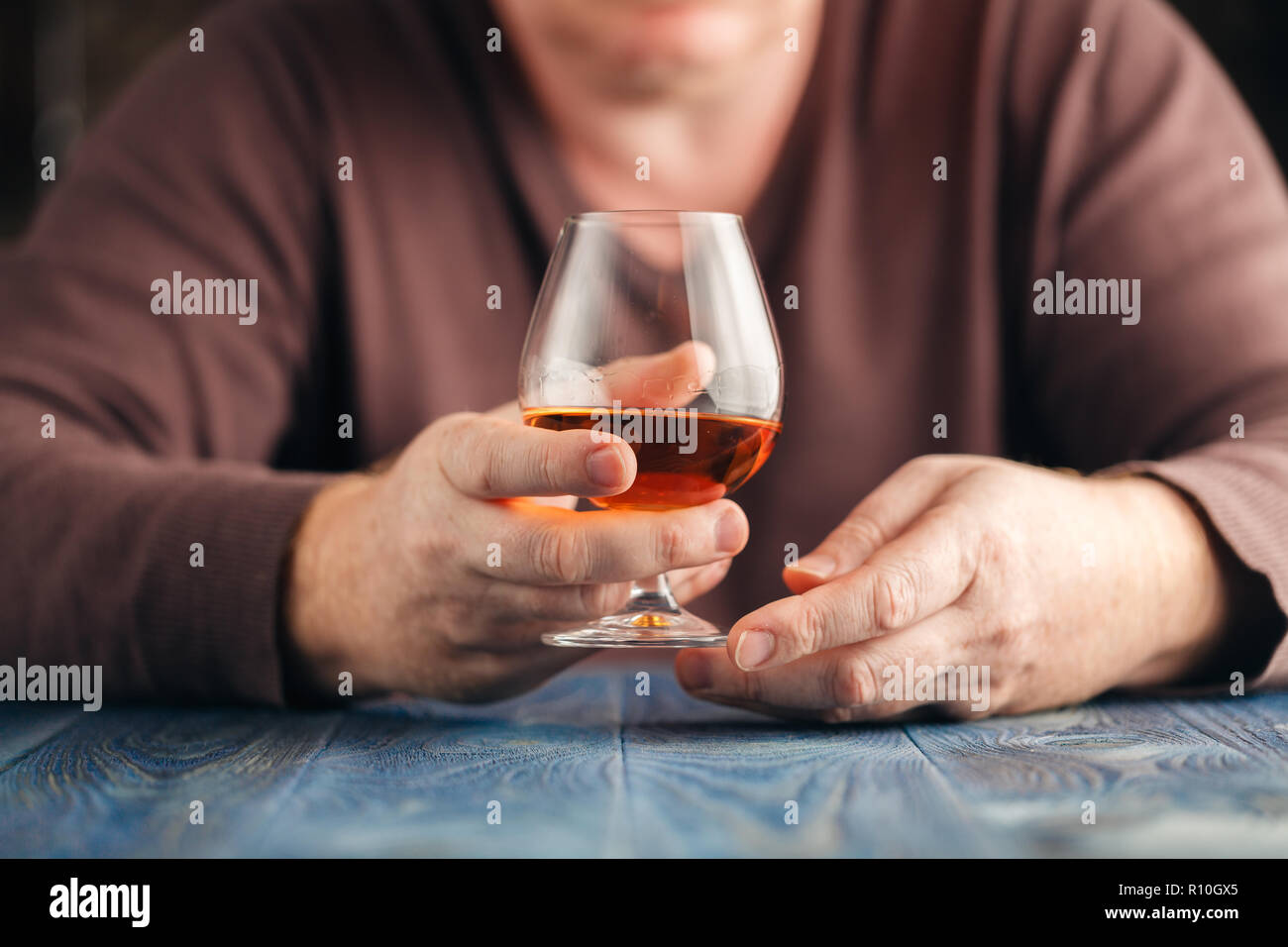 Alcohol abuse, alone man drink whisky for relax Stock Photo - Alamy