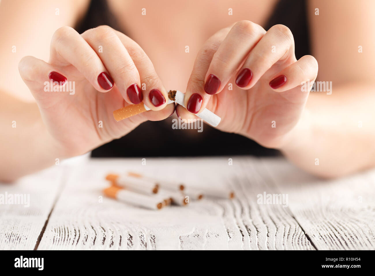 Woman breaks down the cigarette Stock Photo - Alamy