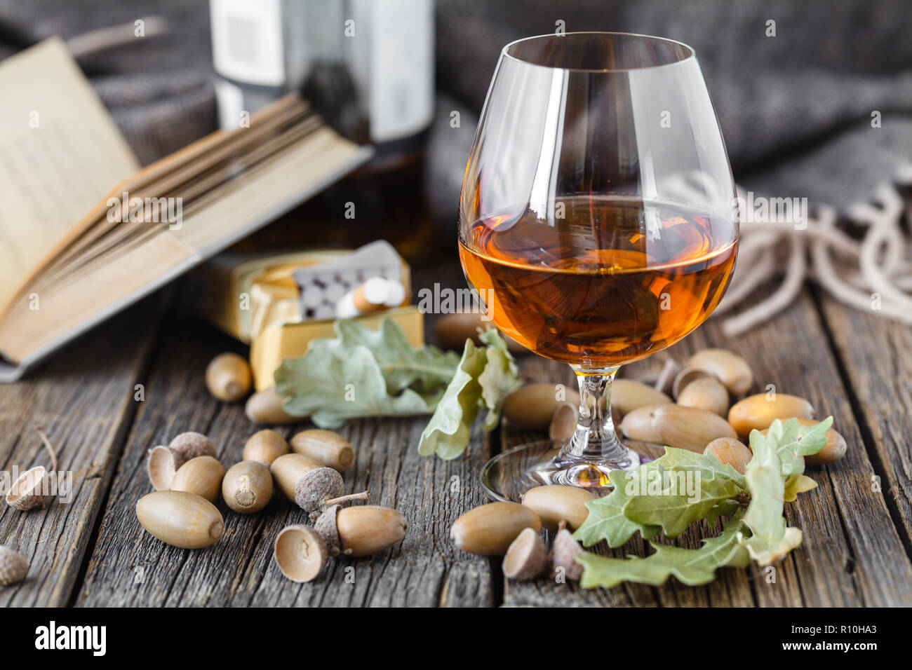 Glass oа amber color whisky in glass on oak table Stock Photo - Alamy