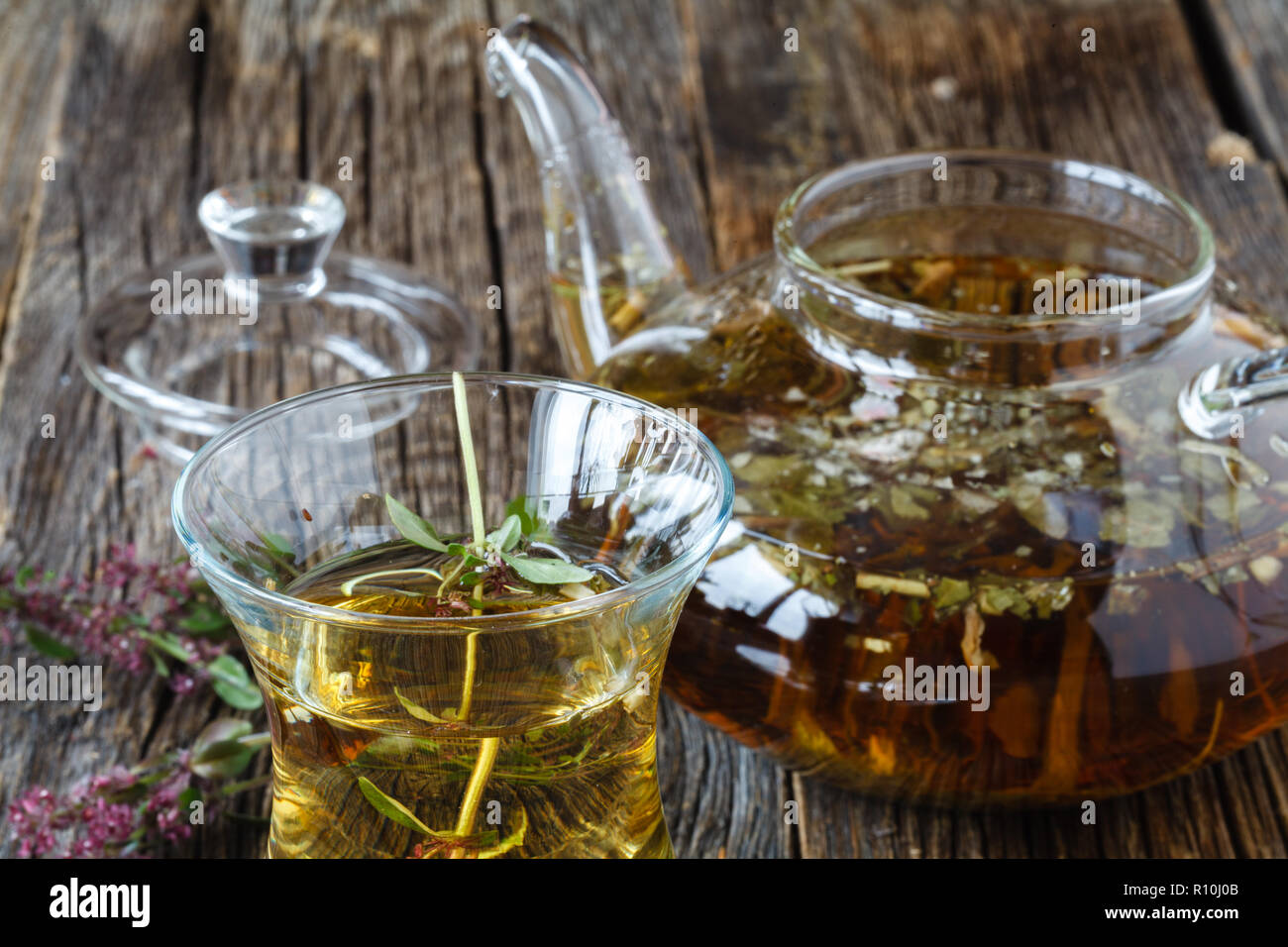 Middle East Black tea with thyme, ethnic glass and glass teapot ...