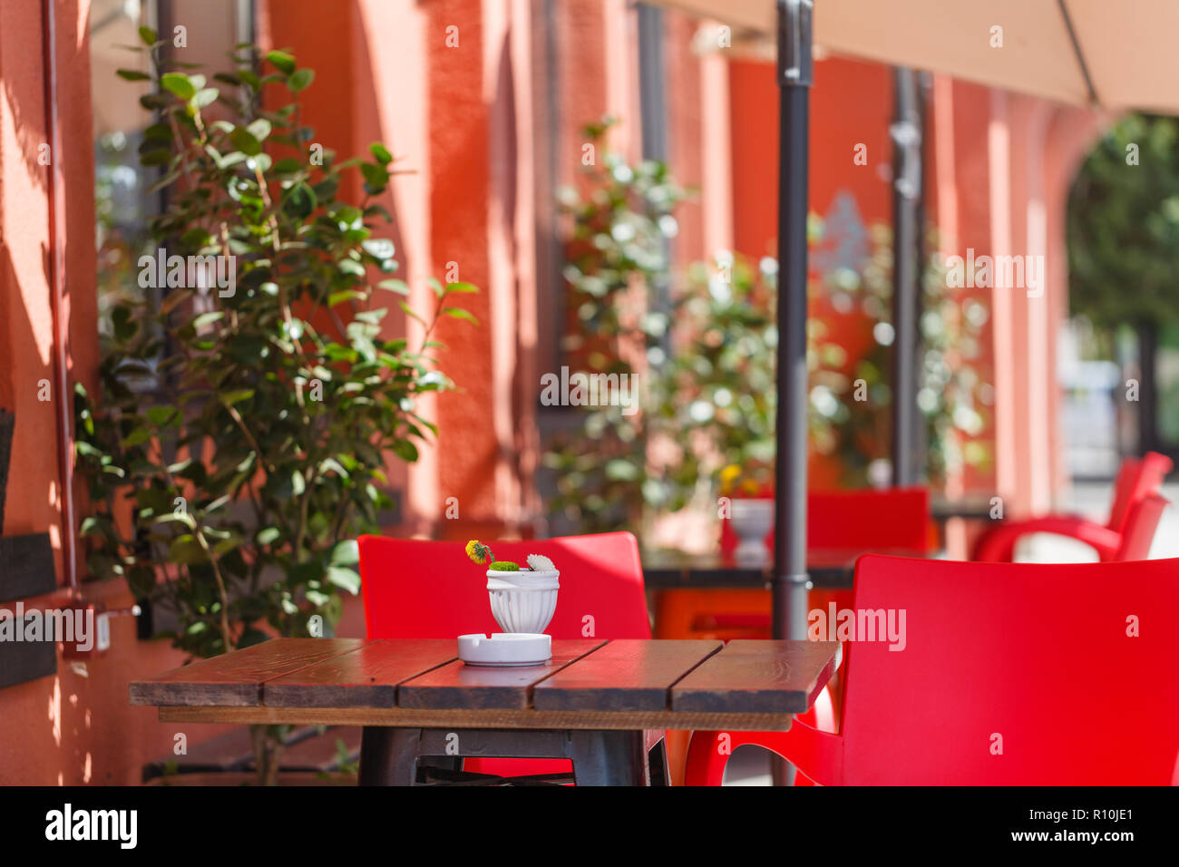 Outdoor restaurant with red tables and chairs Stock Photo - Alamy