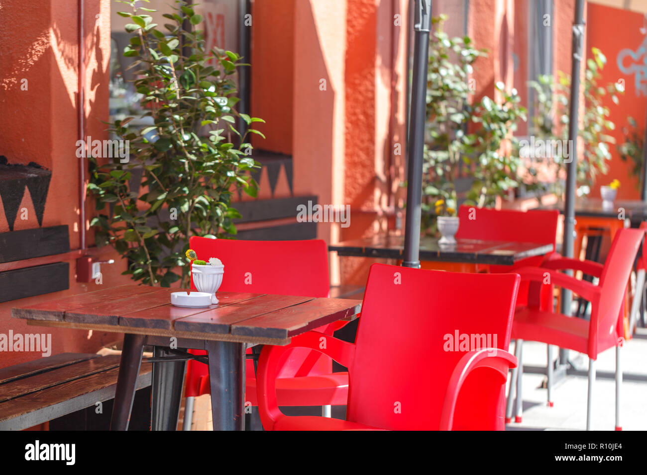 Outdoor restaurant with red tables and chairs Stock Photo - Alamy