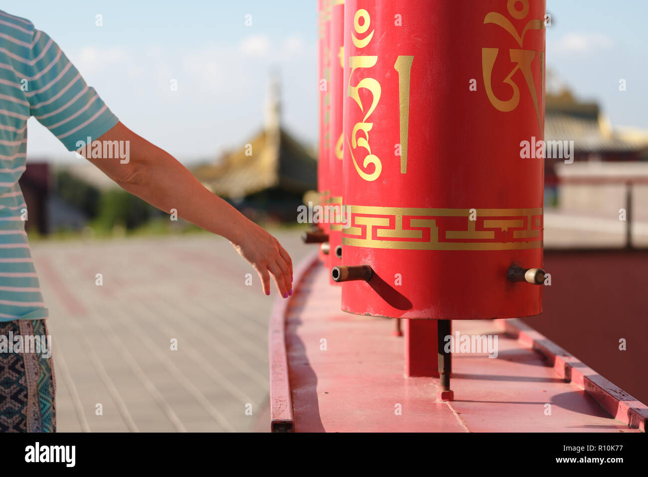 Female hand on the buddhist prayer drum Stock Photo - Alamy