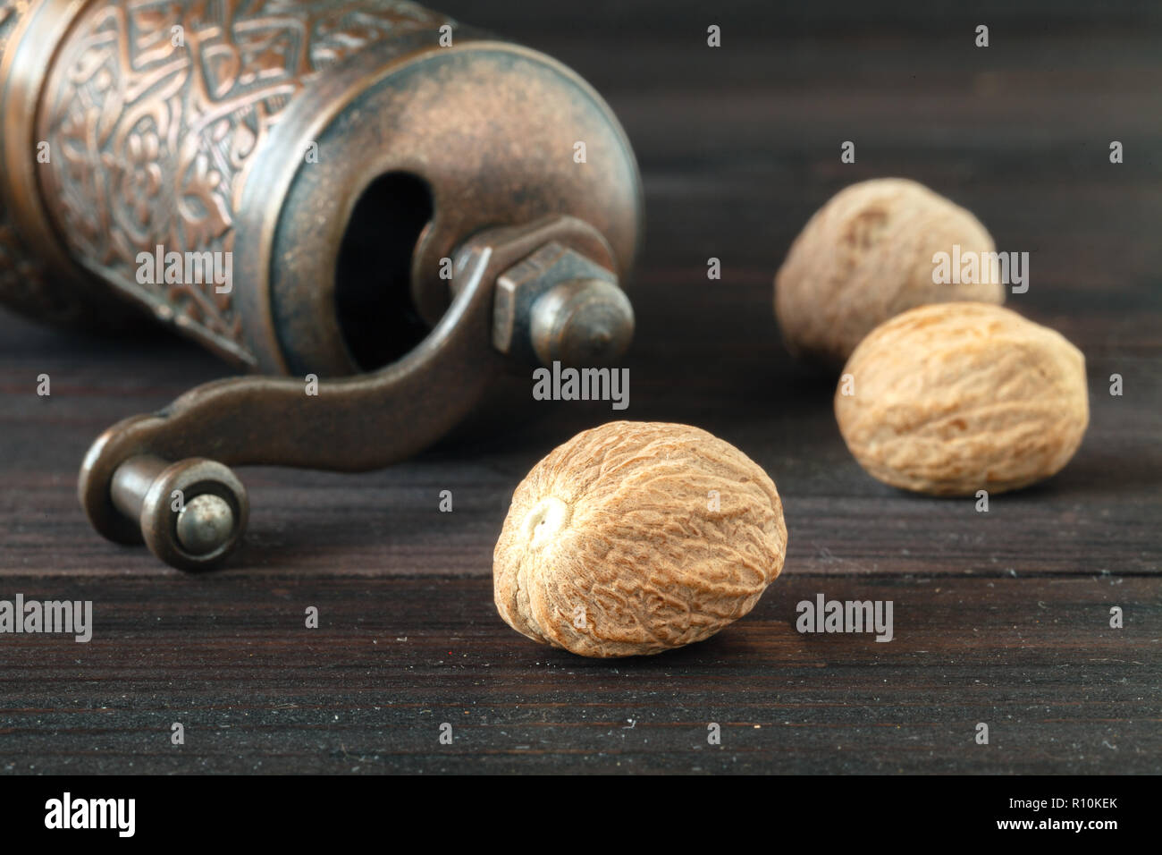 dry nutmeg on dark wooden table Stock Photo - Alamy