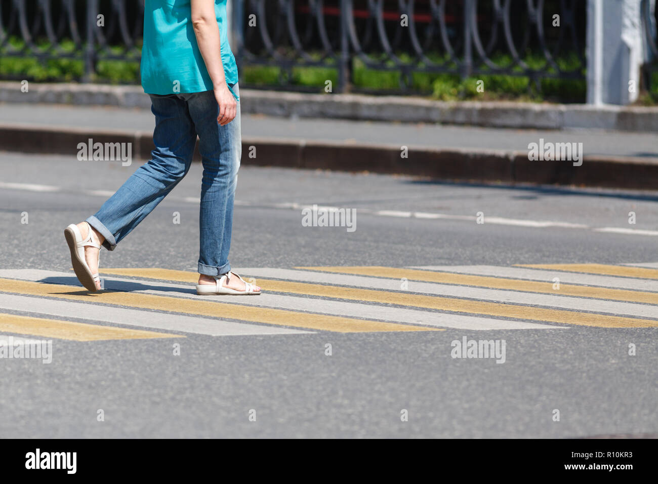 Beautiful woman crossing on crosswalk Stock Photo - Alamy