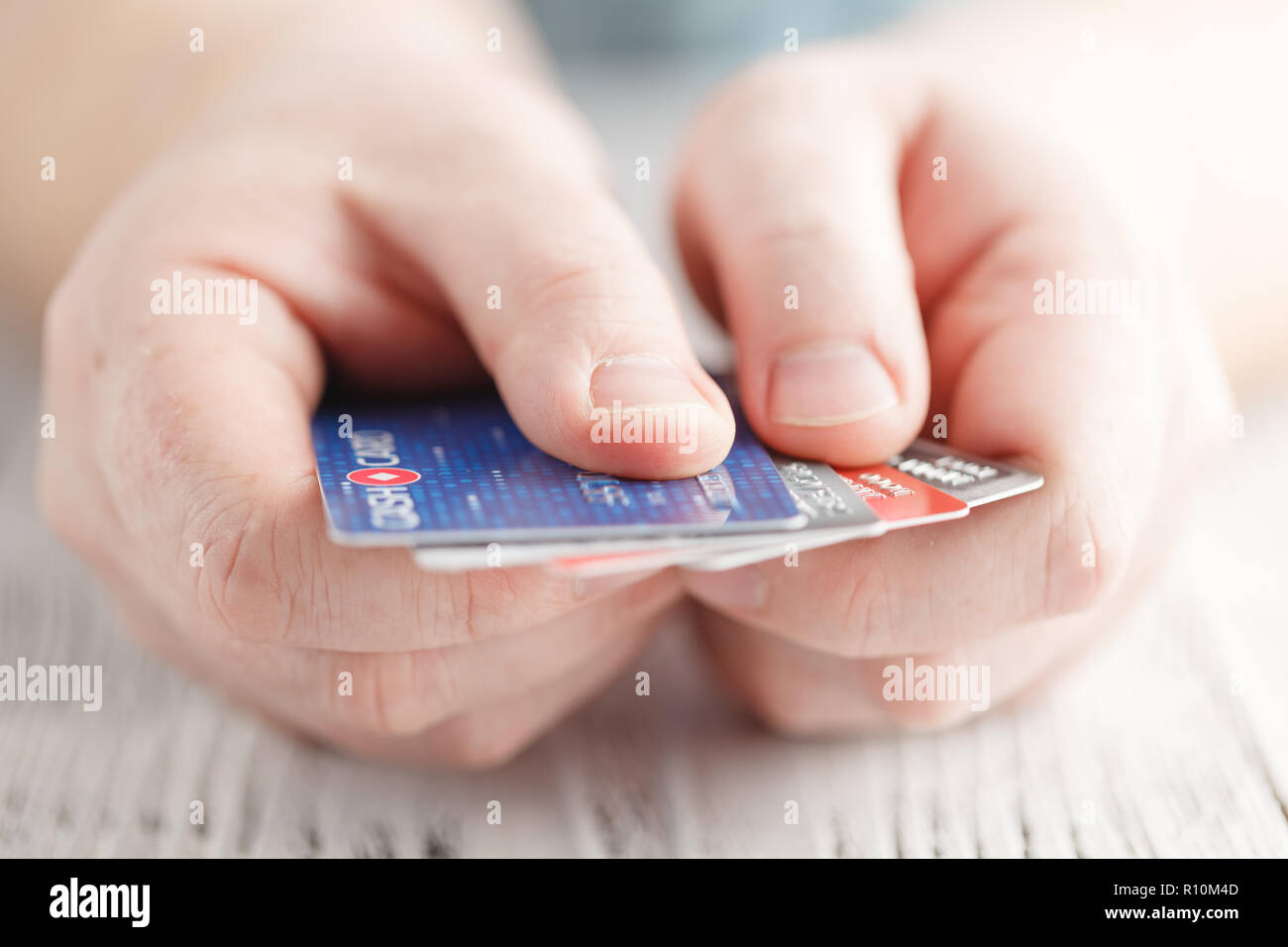 Male holding out debit cards Stock Photo - Alamy