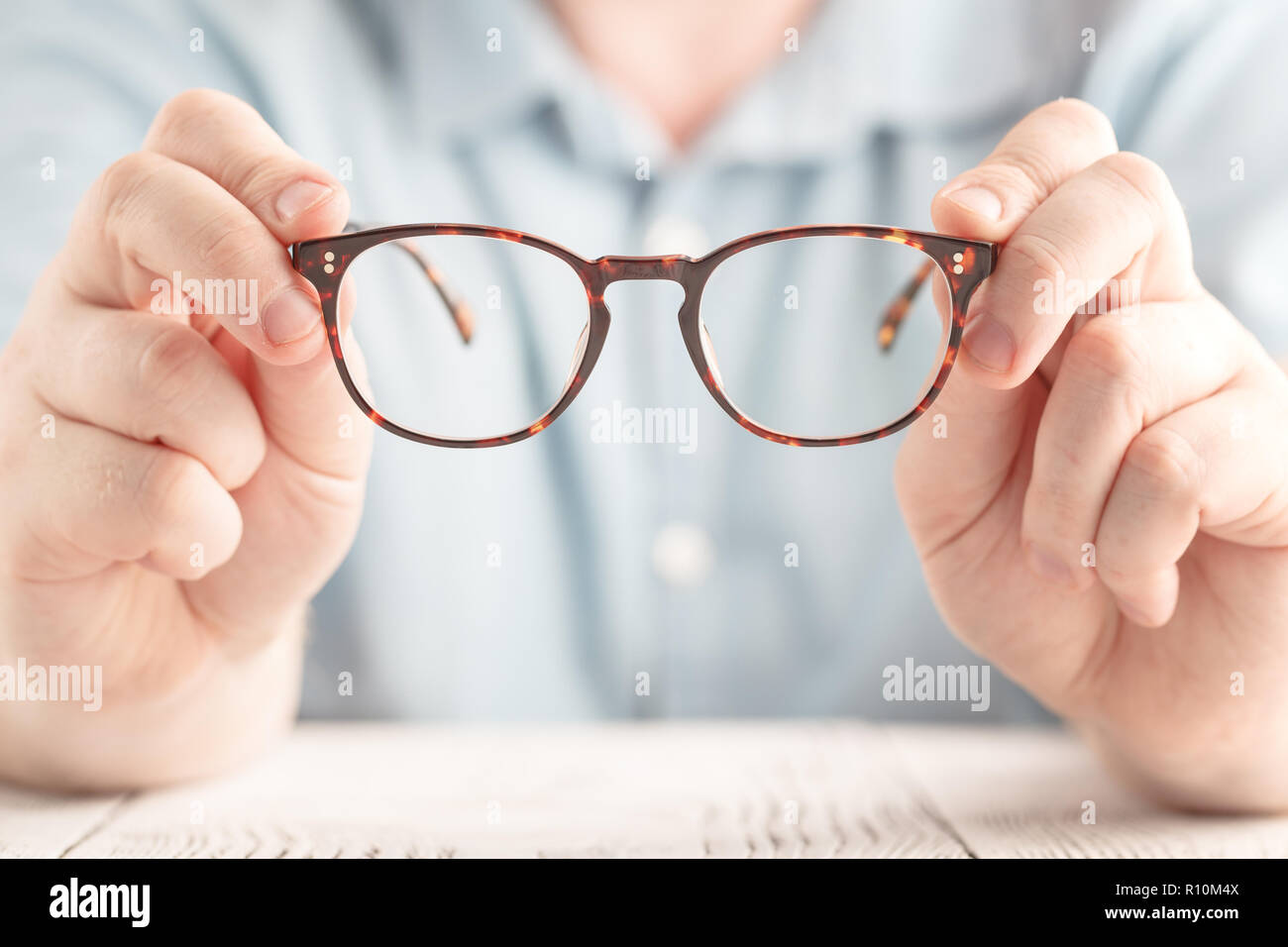 Closeup image: two hands holding classic glasses Stock Photo - Alamy