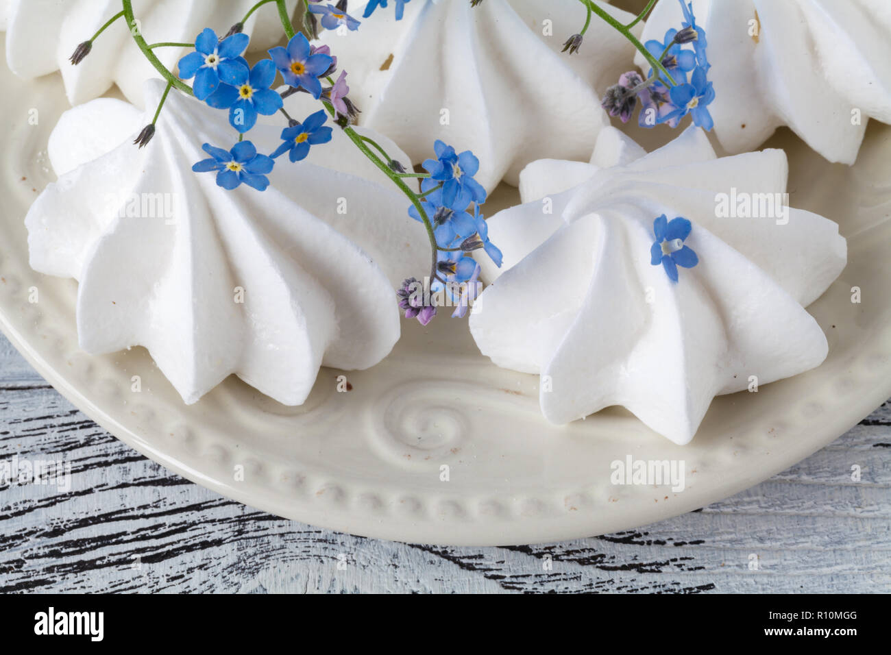 Bouquet spring flowers, coffee cup, marshmallows on wooden Stock Photo ...