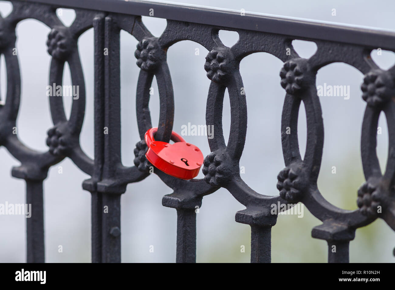 red lock hanging on forged fence Stock Photo - Alamy