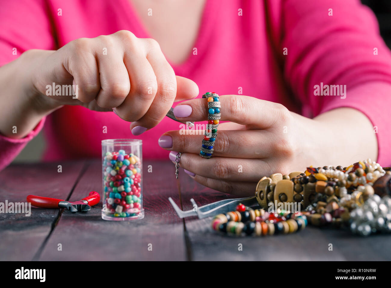 Relax hobby. Female make craft beads Stock Photo - Alamy
