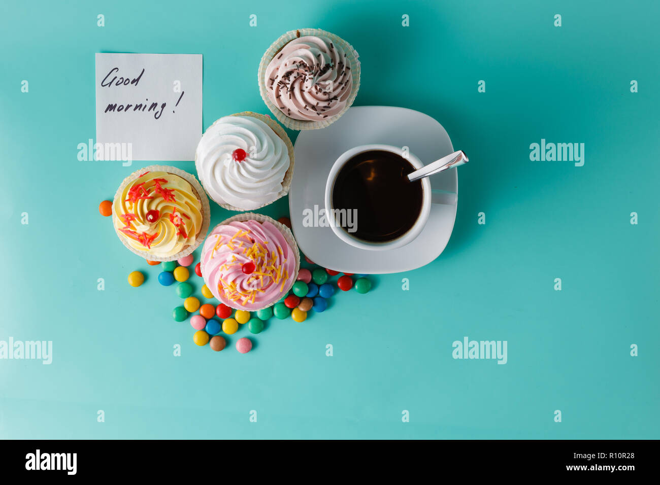 Cupcakes with colorful confetti and coffee cup. Paper notes with ...