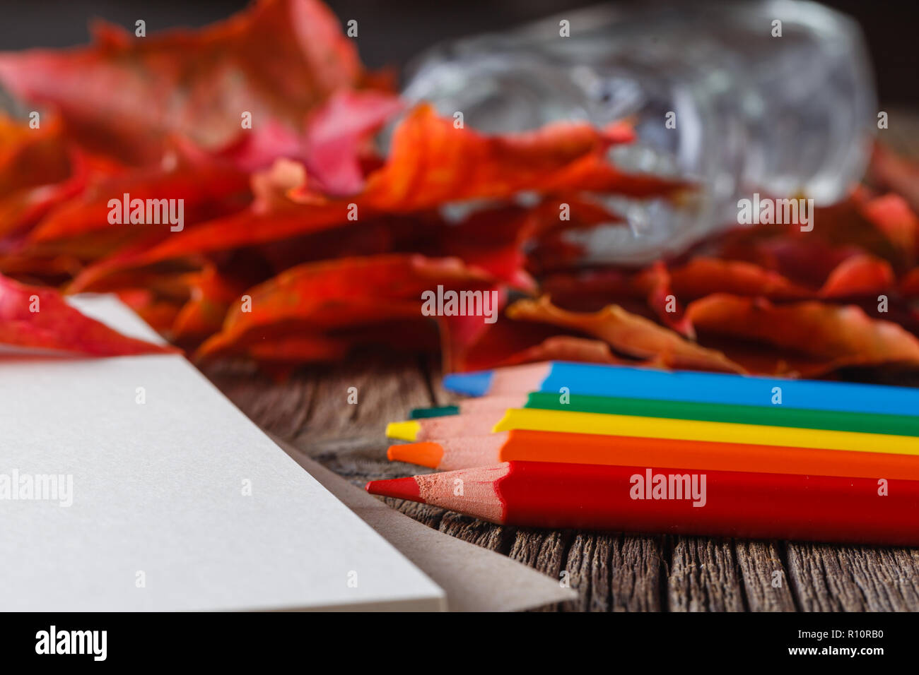 Open sketchbook with pens. Fall on leaves on weathered table Stock ...