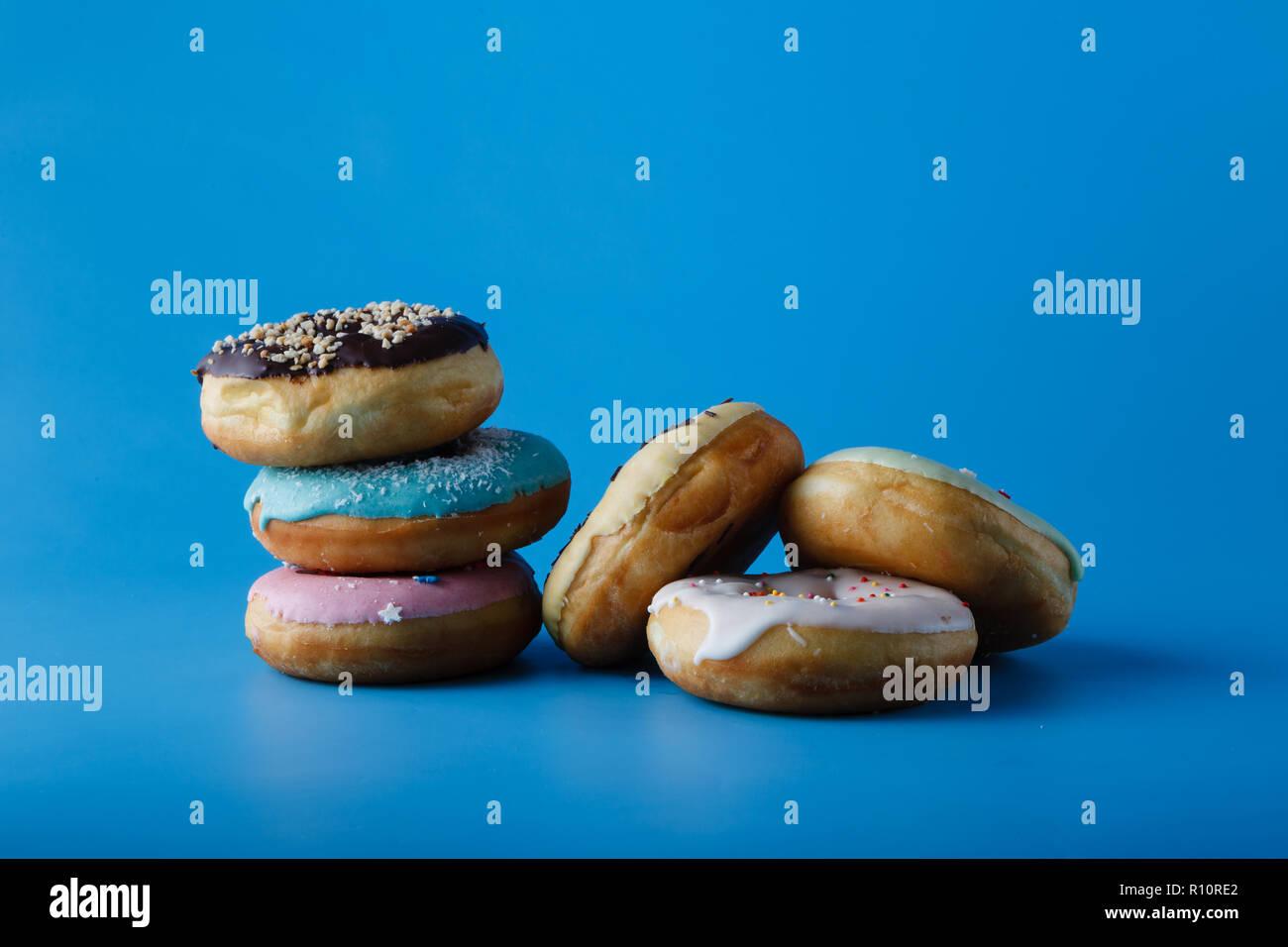 Six donuts on blue shadeless background Stock Photo - Alamy