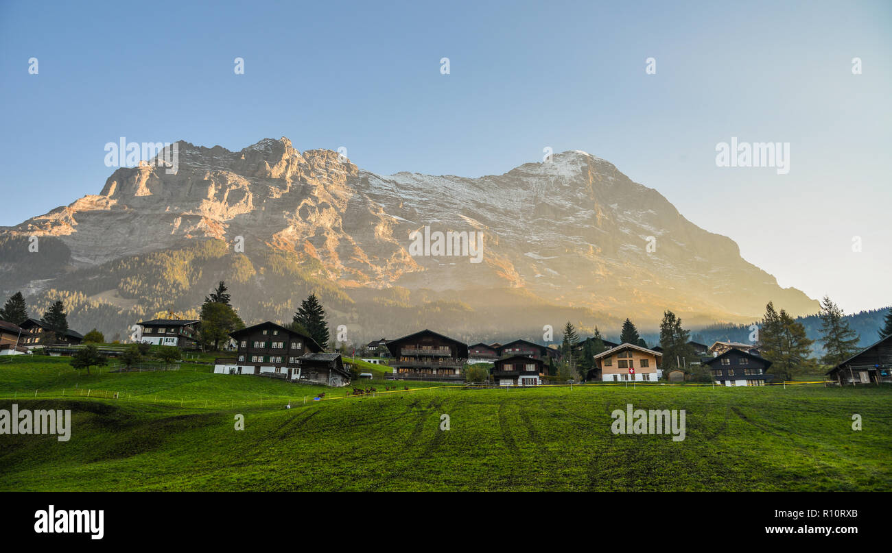 Mountain village at sunset in Grindelwald, Switzerland. Grindelwald was ...