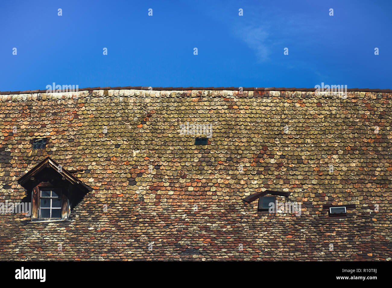 Old tile roof texture with small windows Stock Photo - Alamy