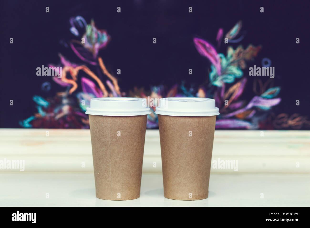 Two carton paper cups with cap at the bar with autumn pattern Stock ...