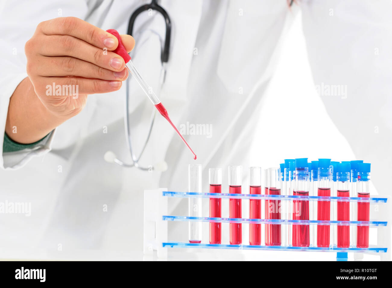 Female doctor filling test tubes with pipette in laboratory Stock Photo ...