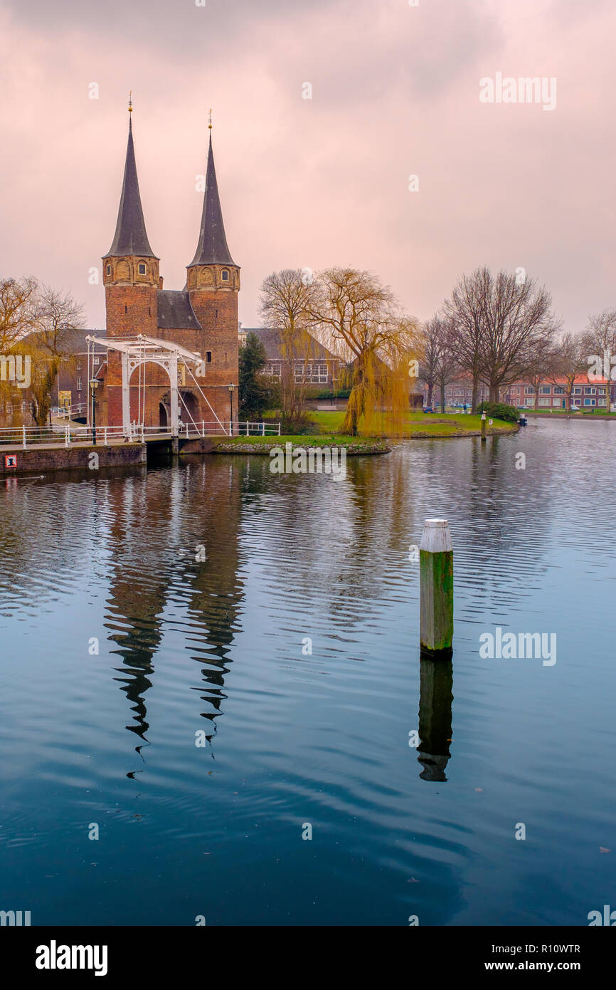Evening view of the canal and the VVE Oostpoort de Delft. Dutch city in ...