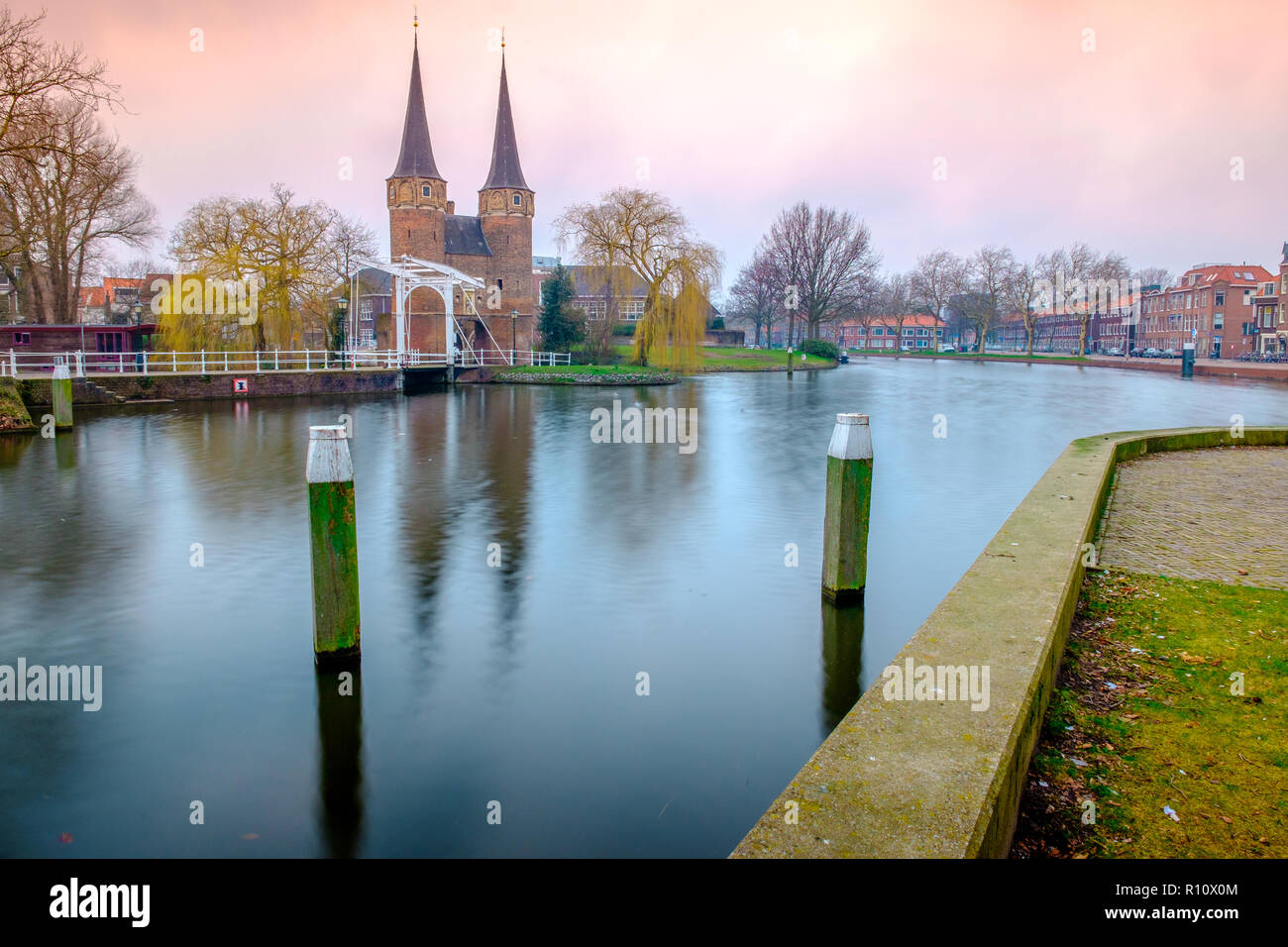 Evening view of the canal and the VVE Oostpoort de Delft. Dutch city in ...