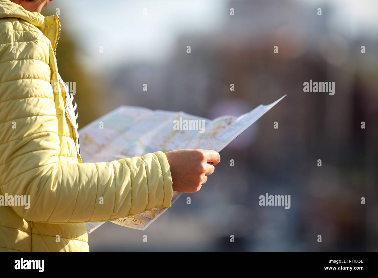 Tourist holding map paper with finding location for travel in city ...